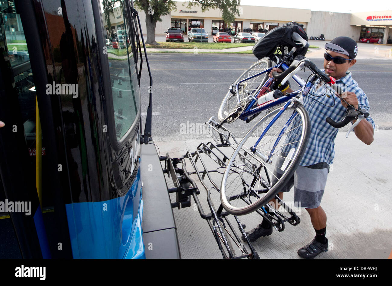 Morning commuters riding bicycles use rack to load their bikes onto a ...