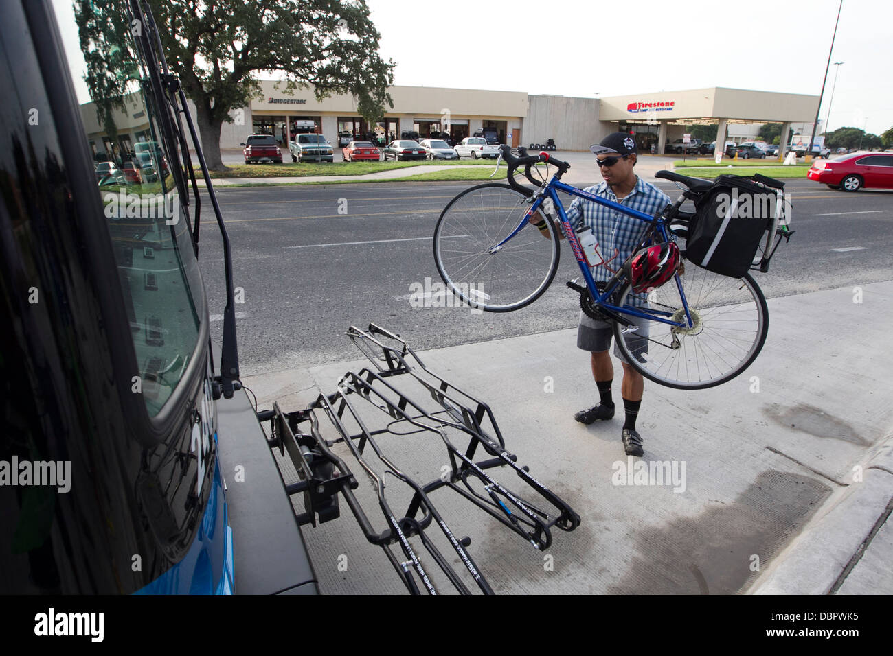 Morning commuters riding bicycles use rack to load their bikes onto a ...