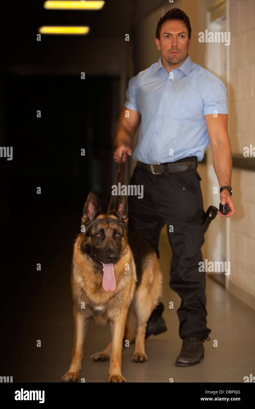 Security guard checking building at night Stock Photo - Alamy
