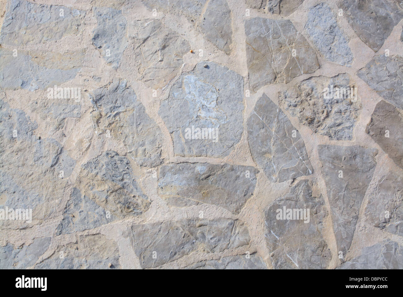 Chunky rocks with cracks in a wall for background Stock Photo - Alamy