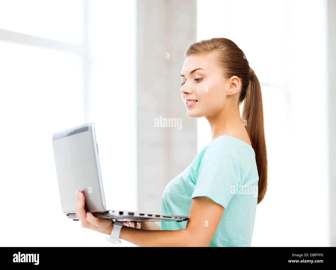 smiling student girl with laptop at school Stock Photo - Alamy