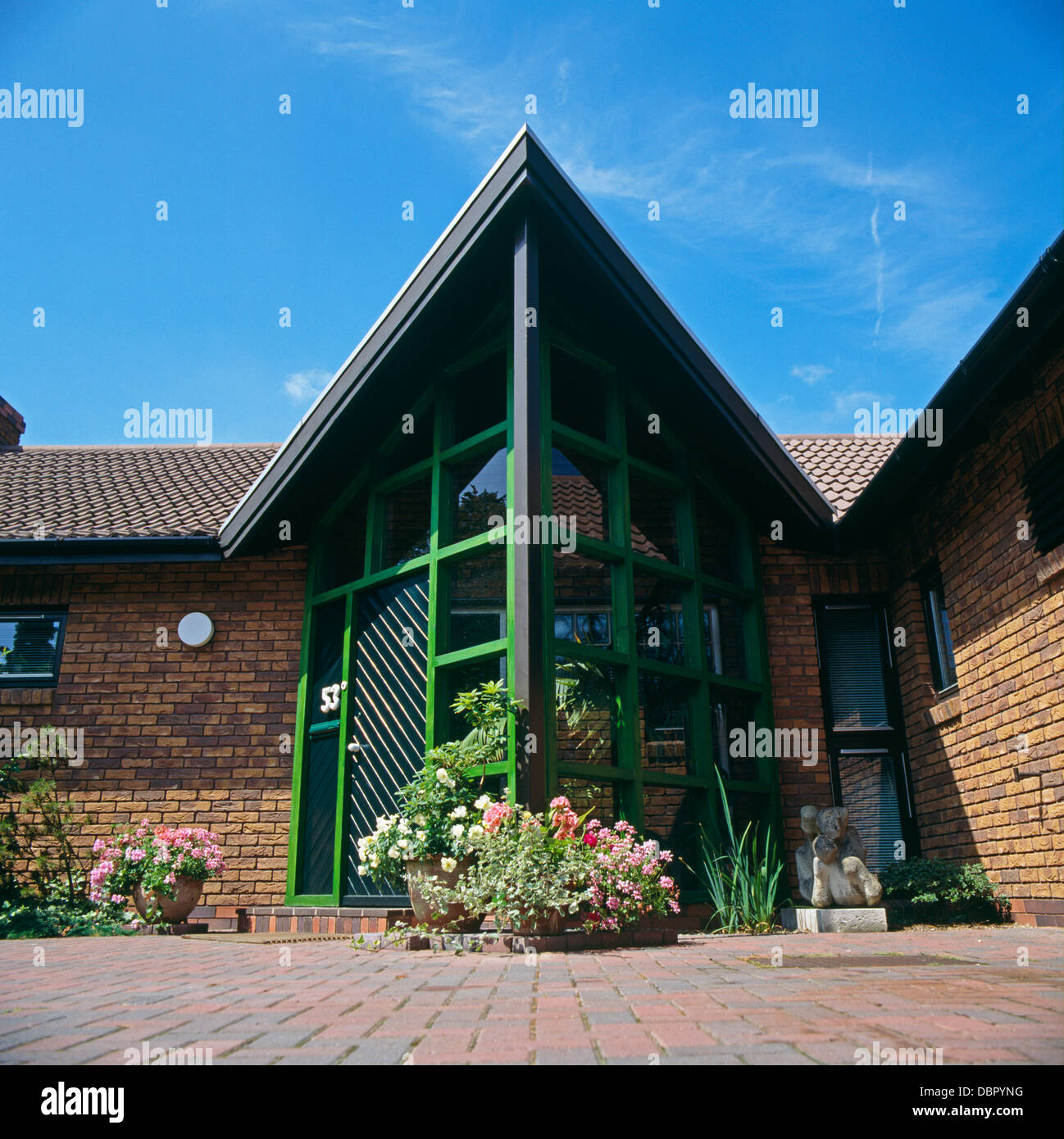 Large, triangular window extension on single story, converted brick ...