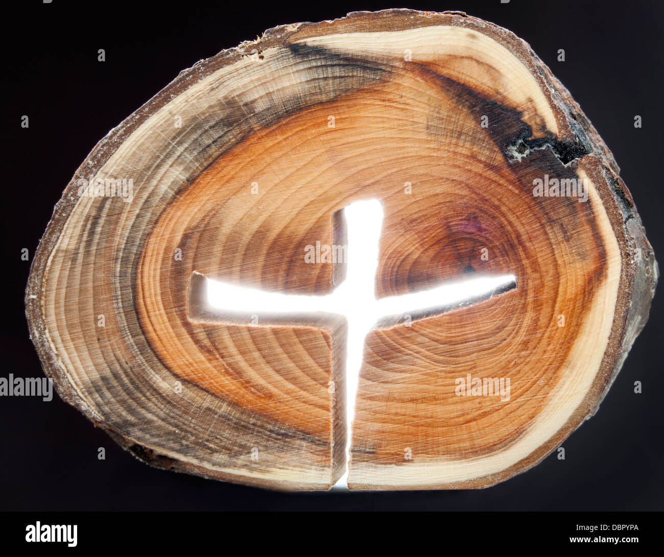 Cross shape cut into wooden block with backlighting Stock Photo - Alamy