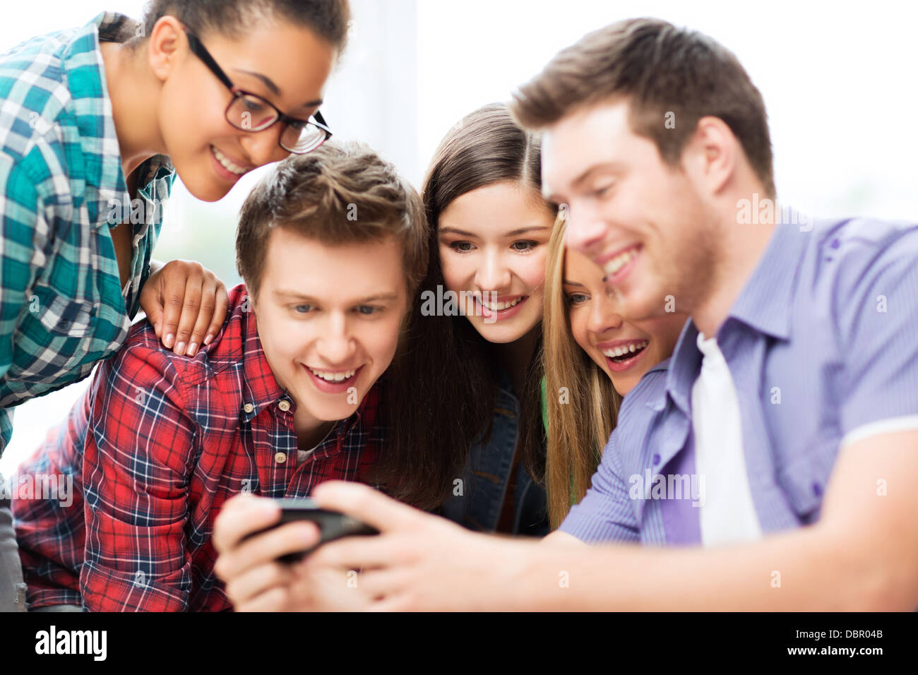 students looking at smartphone at school Stock Photo - Alamy