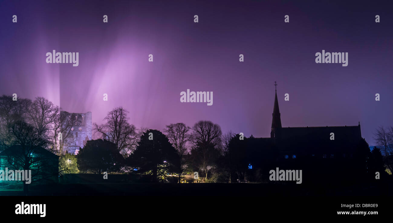 The soptlights of Kelso Abbay light up the misty night sky in the ...