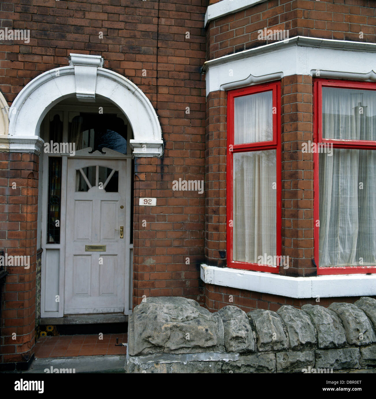 Recessed white door in Victorian town cottage with bay window Stock ...