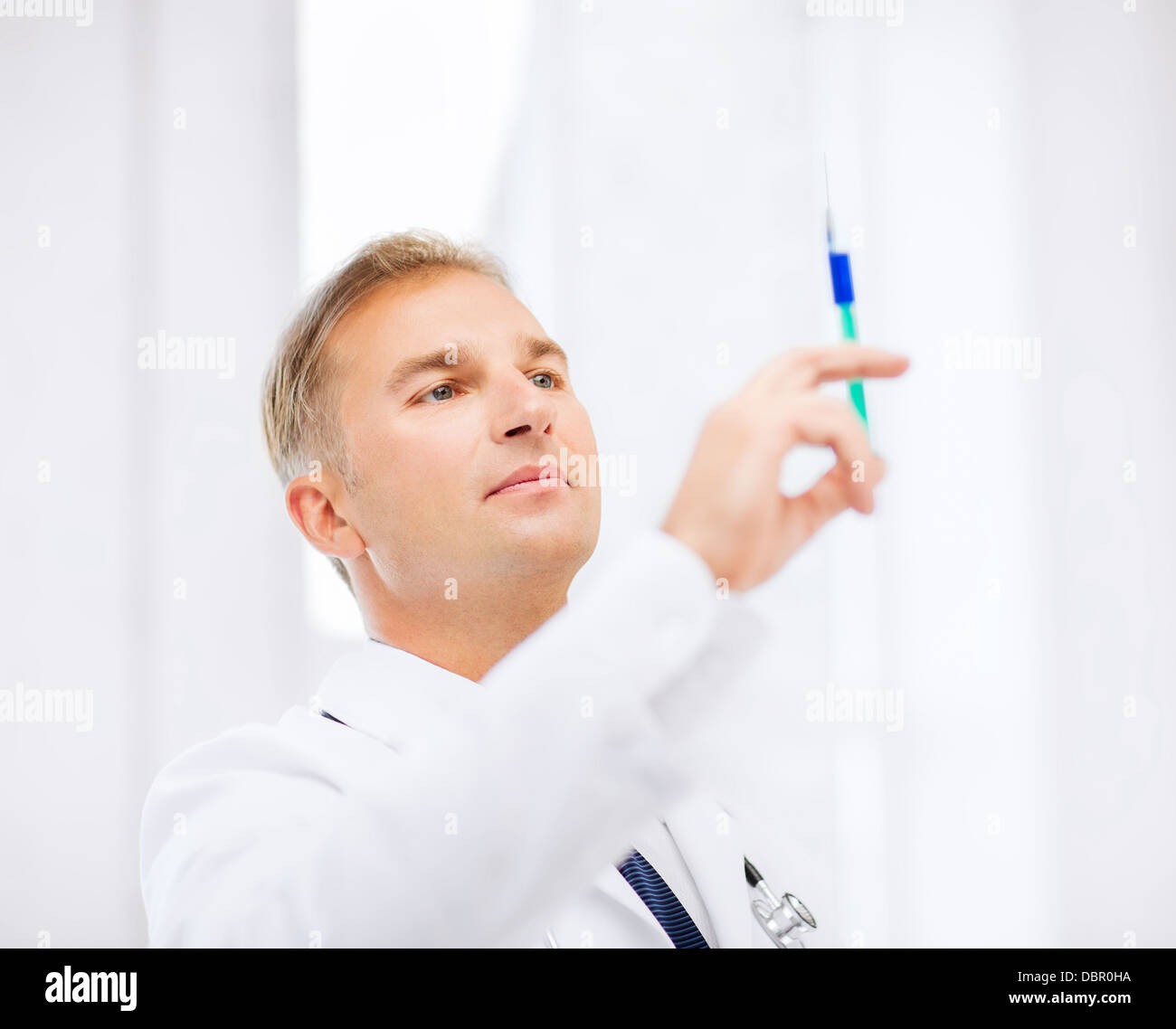 male doctor holding syringe with injection Stock Photo - Alamy