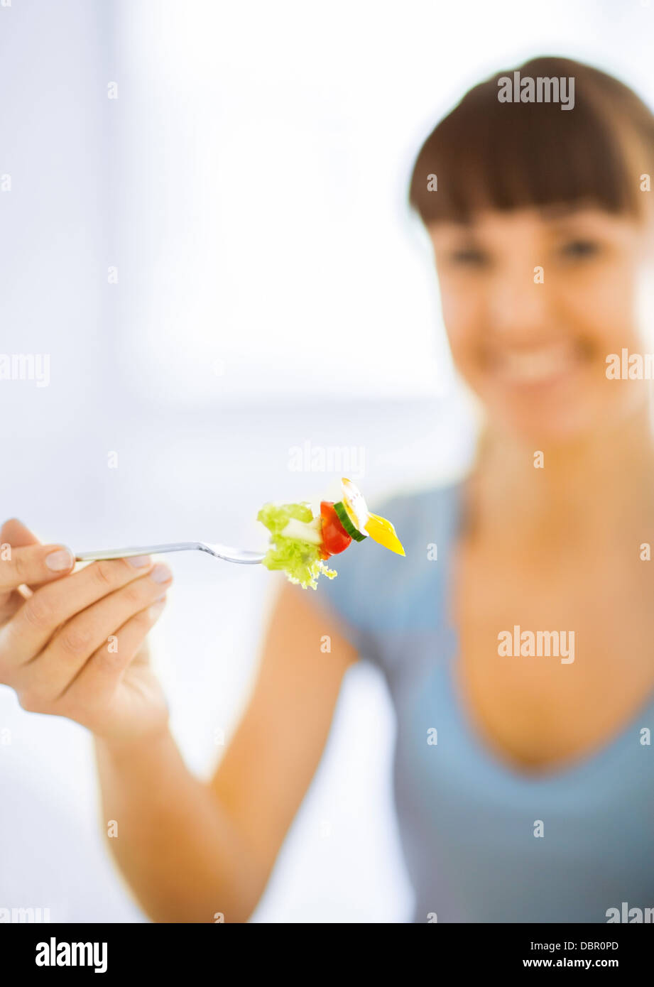woman hand holding fork with vegetables Stock Photo - Alamy