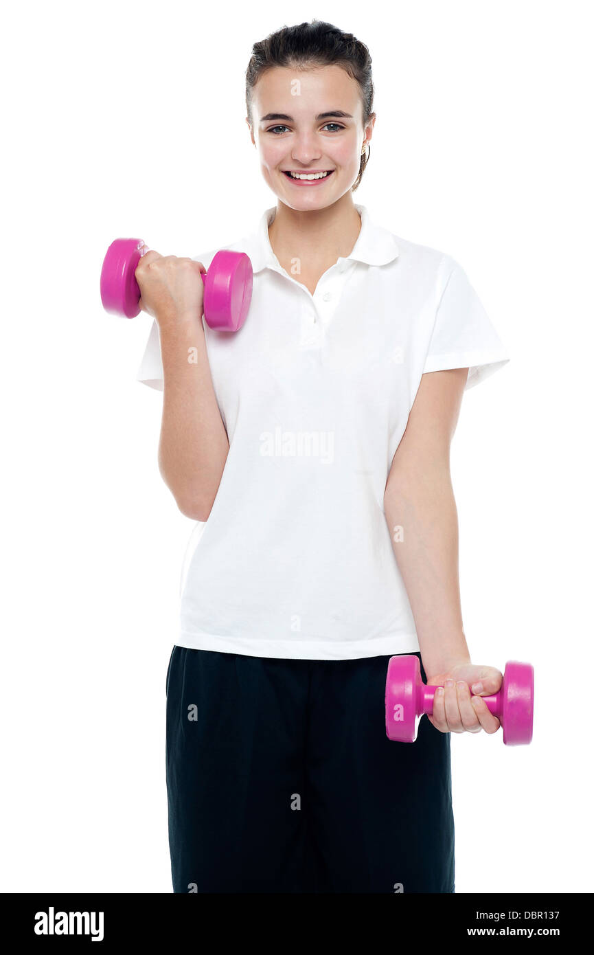 Smiling fitness teenage girl lifting weights Stock Photo - Alamy