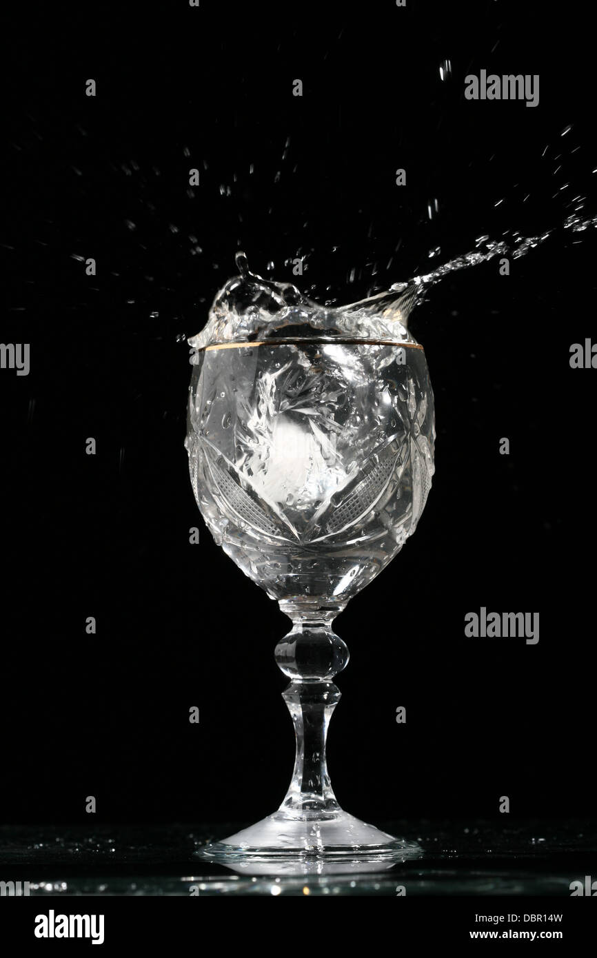 alcohol splash on black background Stock Photo - Alamy