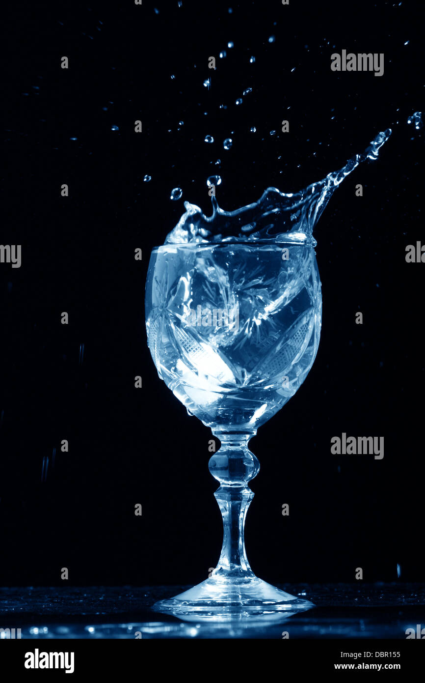 alcohol splash on black background Stock Photo - Alamy