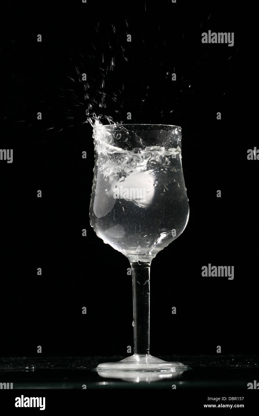 alcohol splash on black background Stock Photo - Alamy