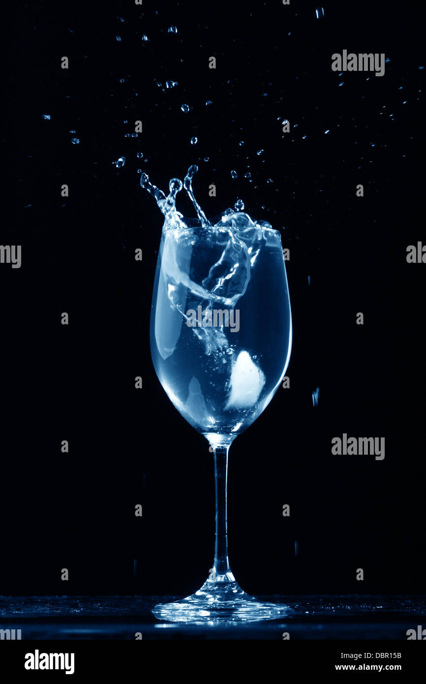 alcohol splash on black background Stock Photo - Alamy