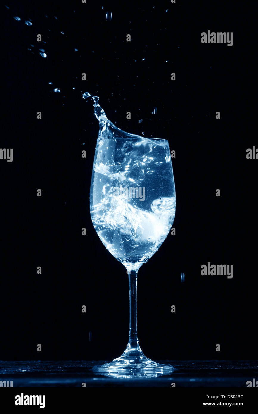 alcohol splash on black background Stock Photo - Alamy