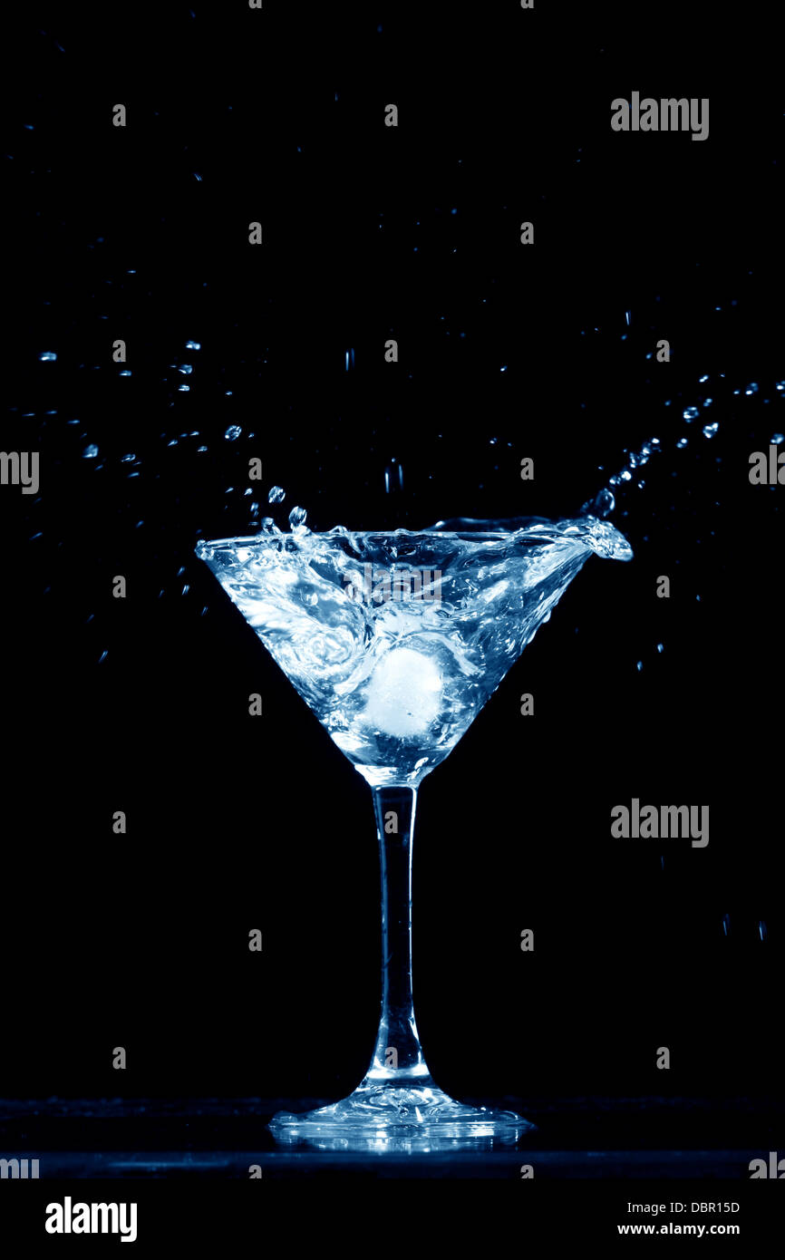 alcohol splash on black background Stock Photo - Alamy