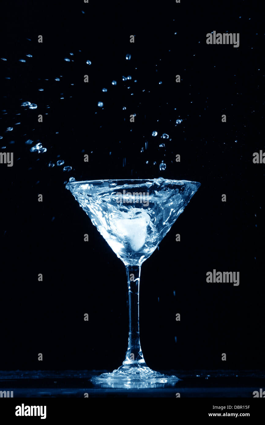 alcohol splash on black background Stock Photo - Alamy