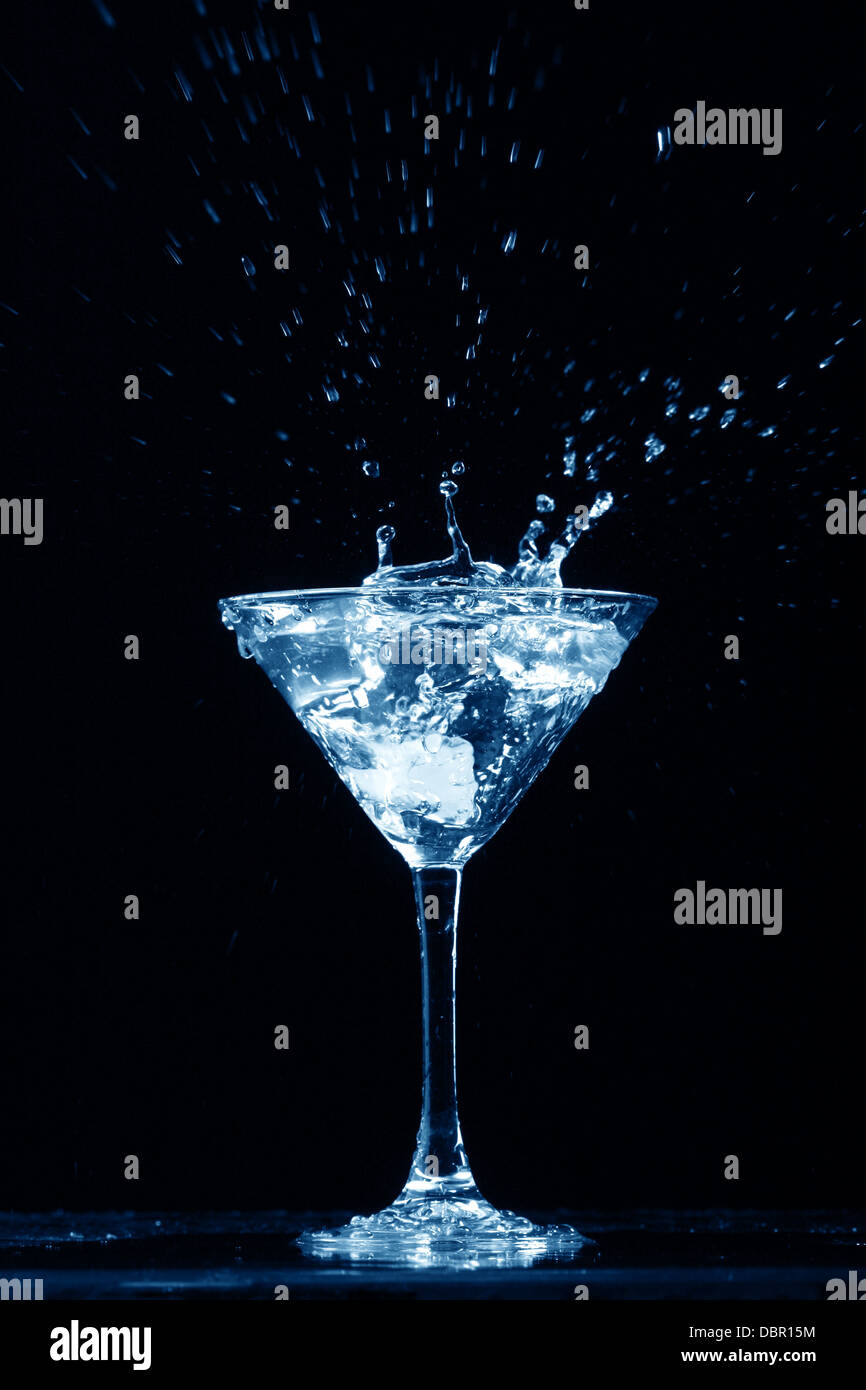 alcohol splash on black background Stock Photo - Alamy