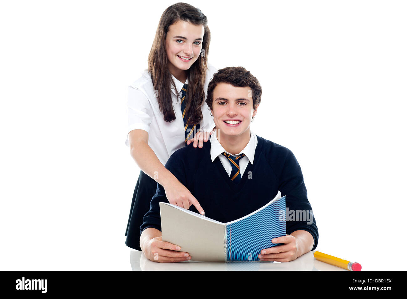 Girl pointing out the answer to her classmate Stock Photo - Alamy