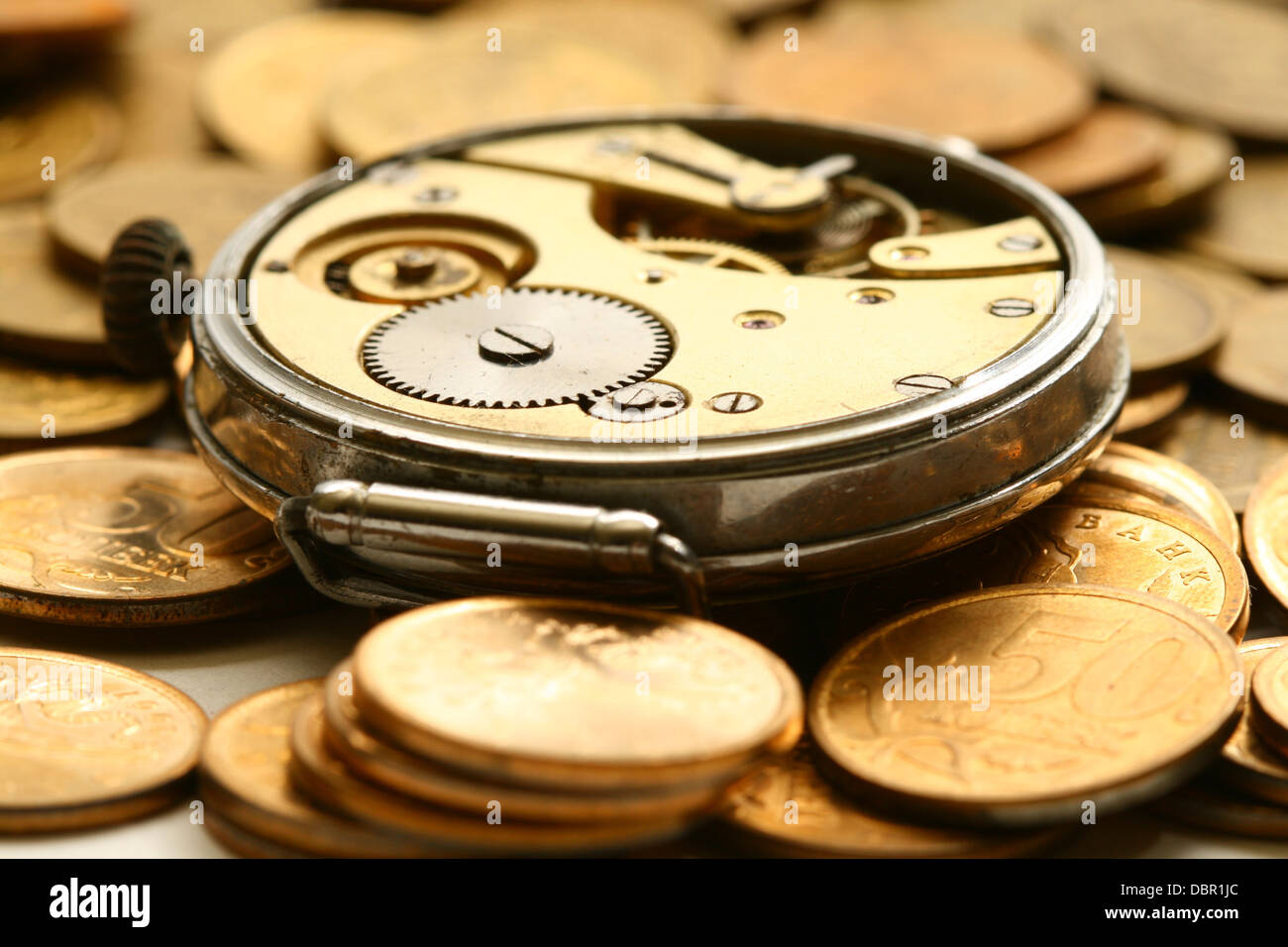 time is money coins and clock macro concet Stock Photo - Alamy