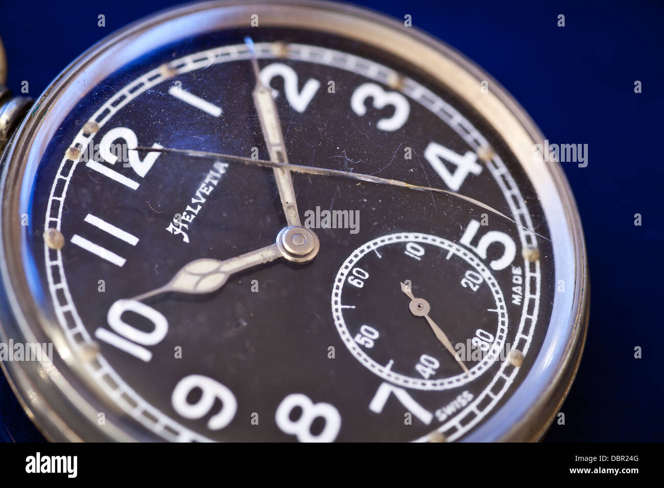 Old broken pocket watch on blue background Stock Photo - Alamy