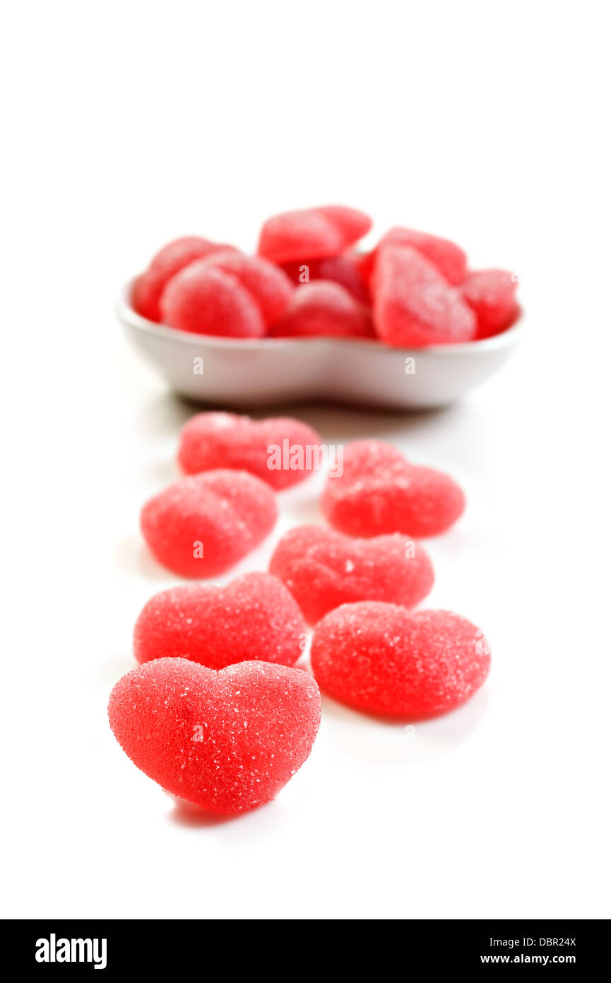 Red heart shaped sweets on white background Stock Photo - Alamy