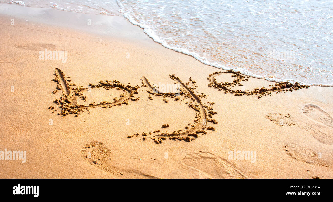 Bye written in the sand on the beach Stock Photo - Alamy