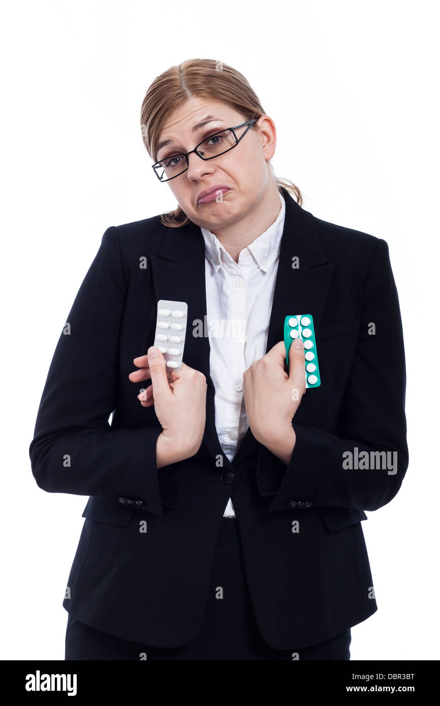 Indecisive business woman holding pills, isolated on white background ...