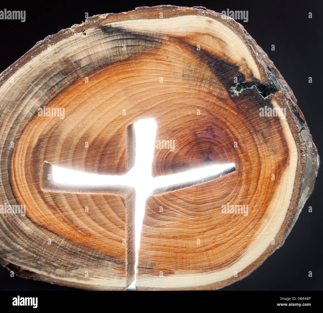 Cross shape cut into wooden block with backlighting Stock Photo - Alamy