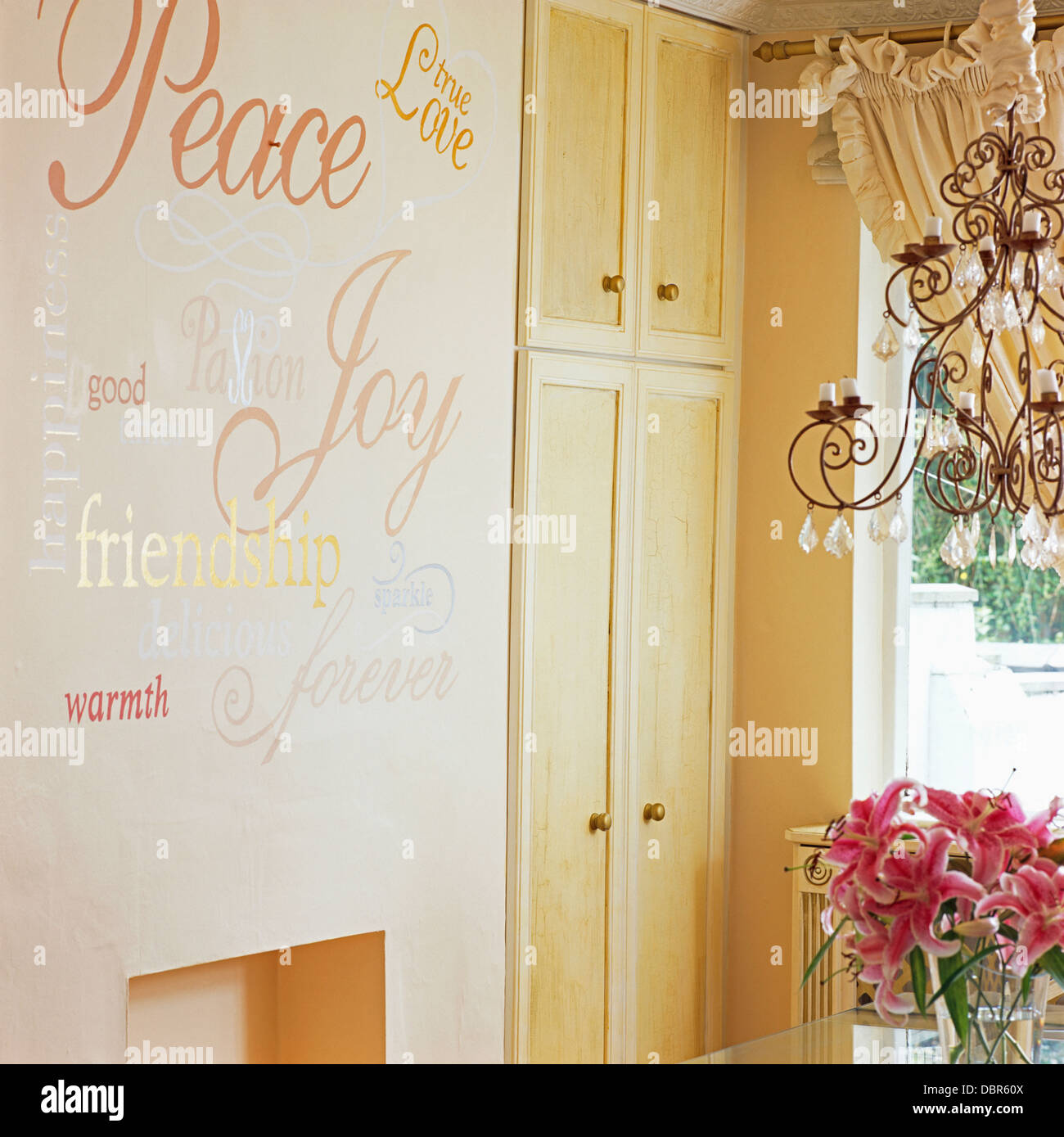 Close-up of wall with hand stenciled lettering in economy style dining ...