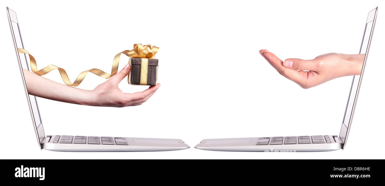 hand with a gift come out from a screen of a laptop computer isolated ...