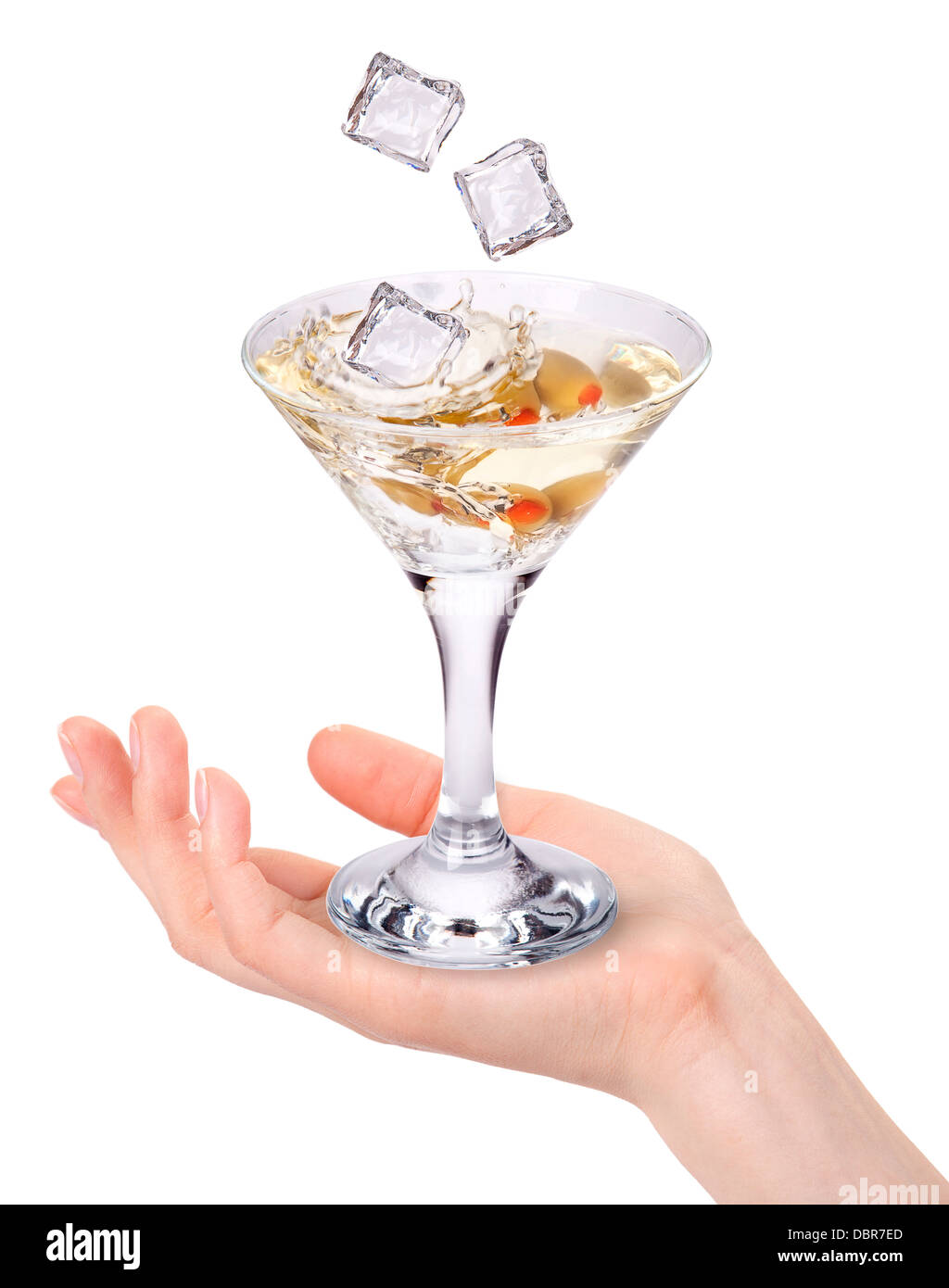 martini with olive and ice splashing - fresh cocktail isolated on a ...