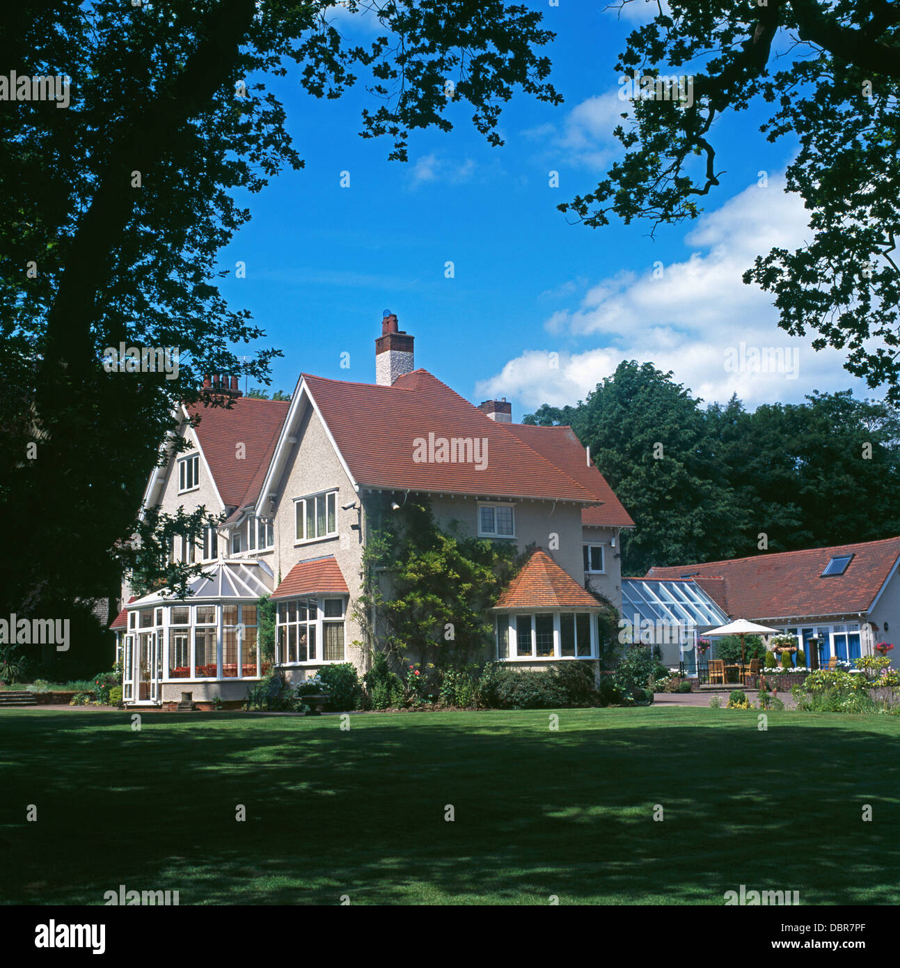 Large lawn in front of Victorian country house with conservatory Stock ...