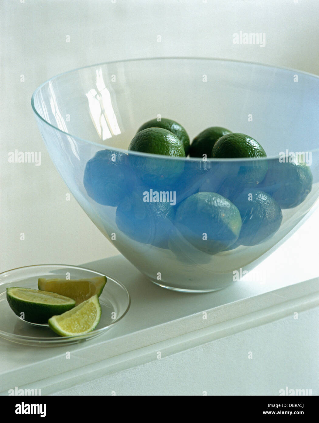Close-up of glass bowl full of limes Stock Photo - Alamy