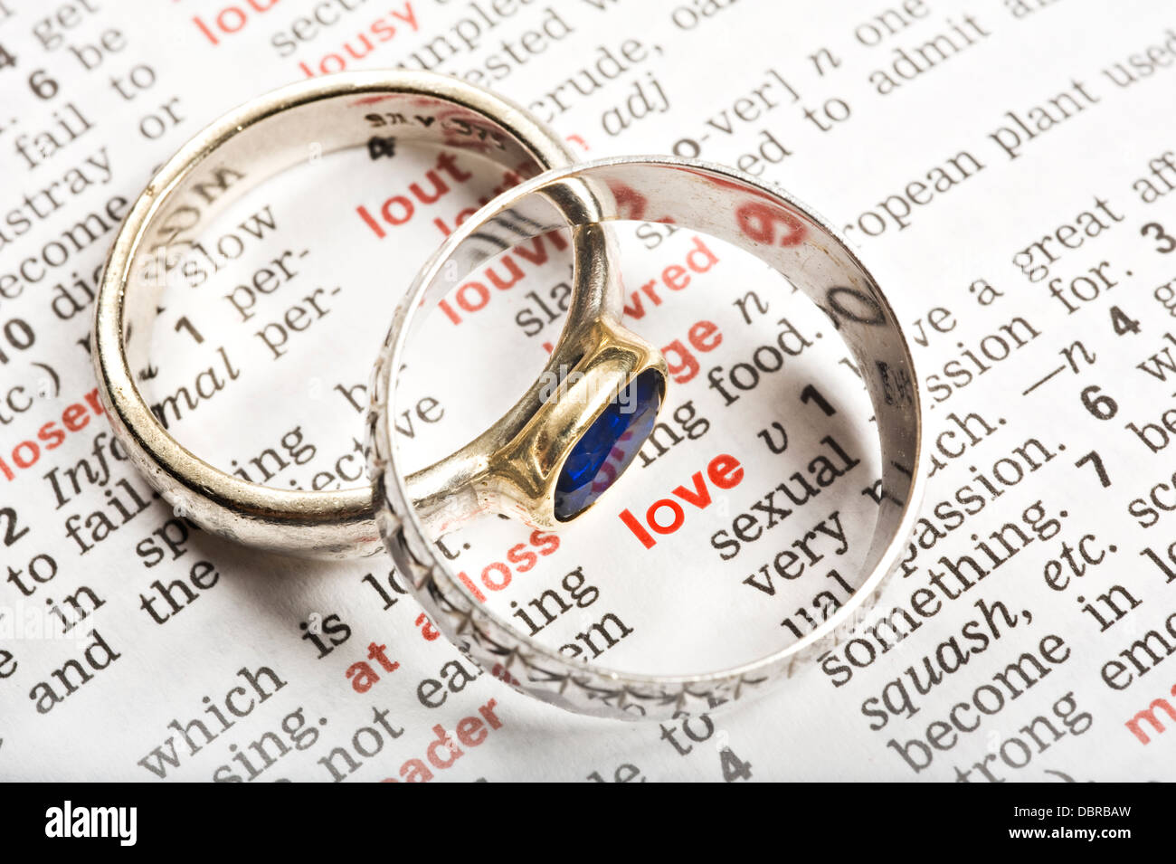 Wedding rings and the word love in dictionary Stock Photo - Alamy