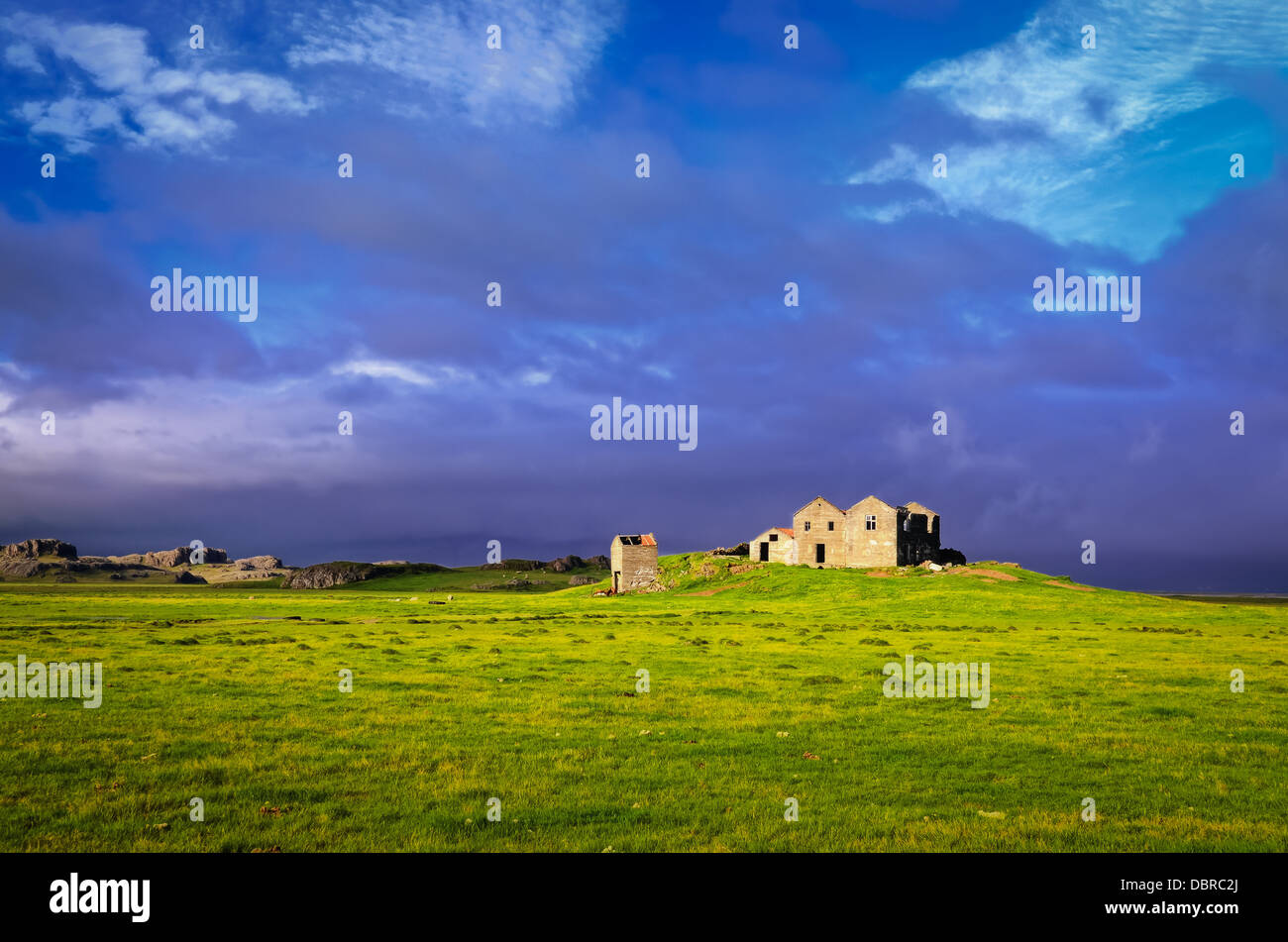 Old rusty house and barn in the green meadow and stormy clouds Stock ...