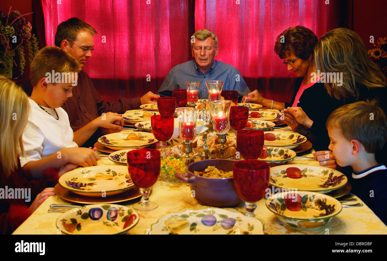 Family Praying Over Thanksgiving Meal Stock Photo - Alamy