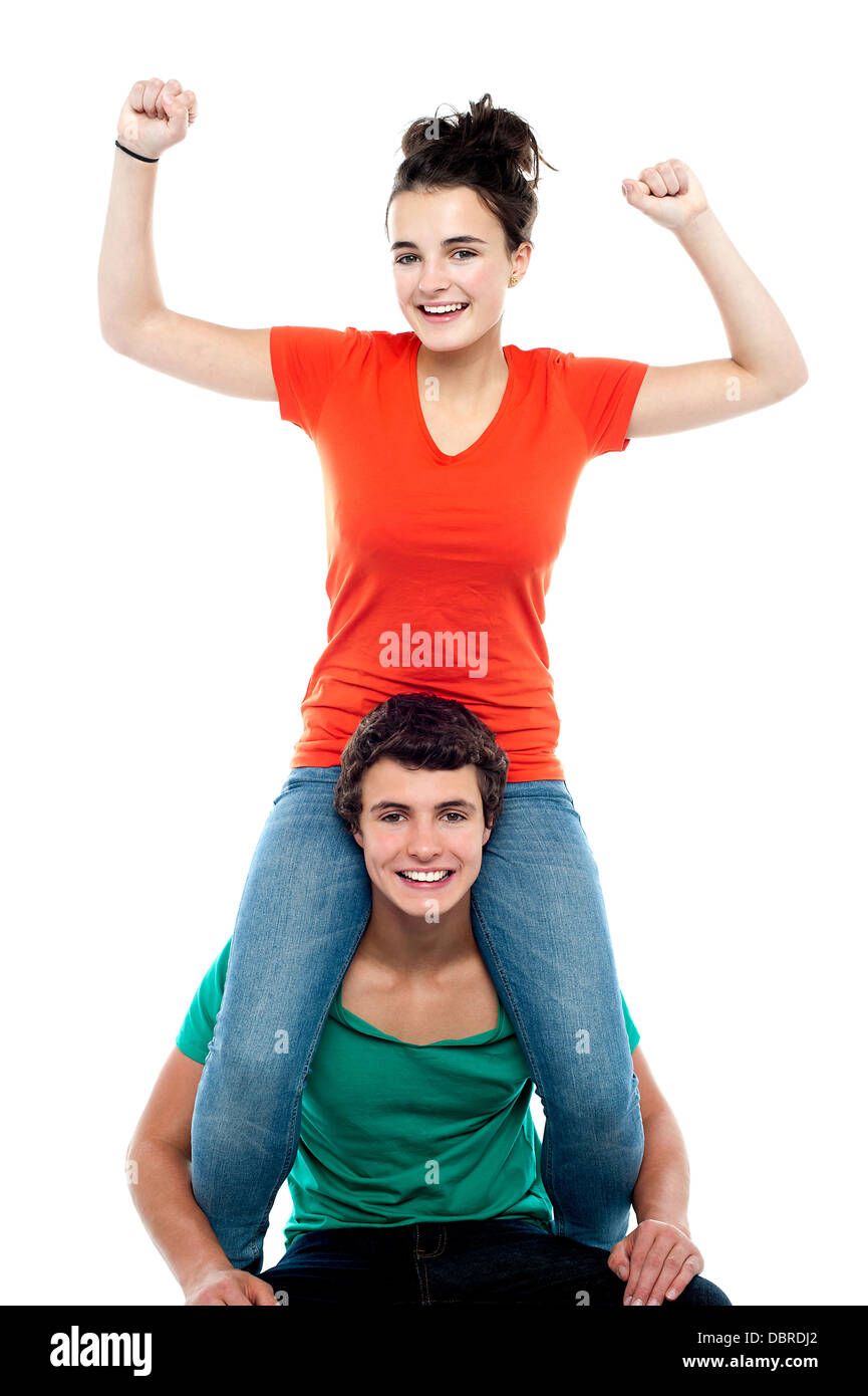 Excited pretty girl enjoying riding on his friends shoulder Stock Photo ...