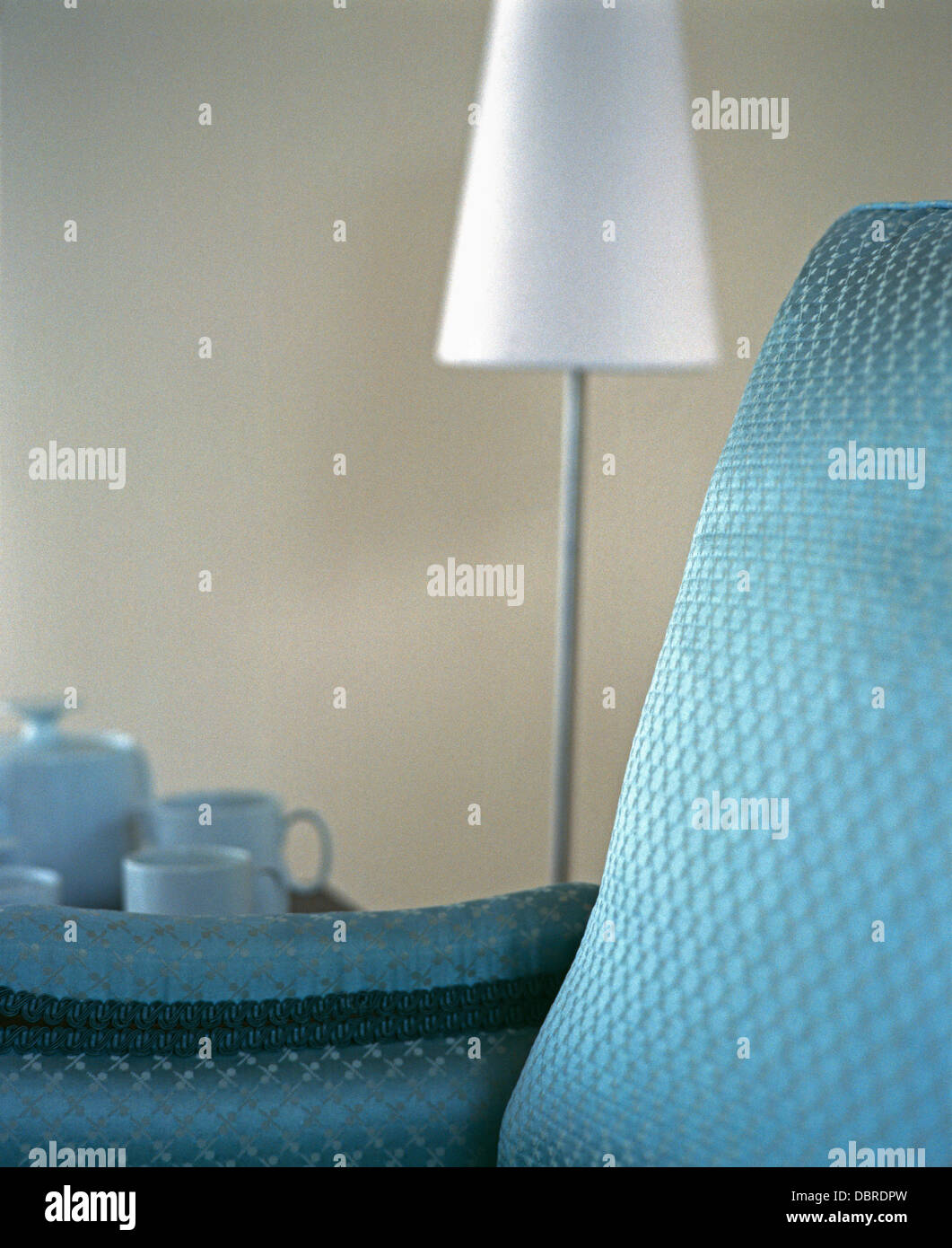 Close-up of pale turquoise chair and modern white lamp Stock Photo - Alamy