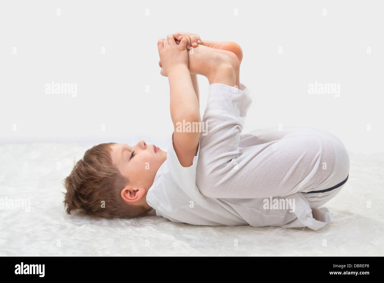 Children's yoga. The little boy does exercise Stock Photo - Alamy