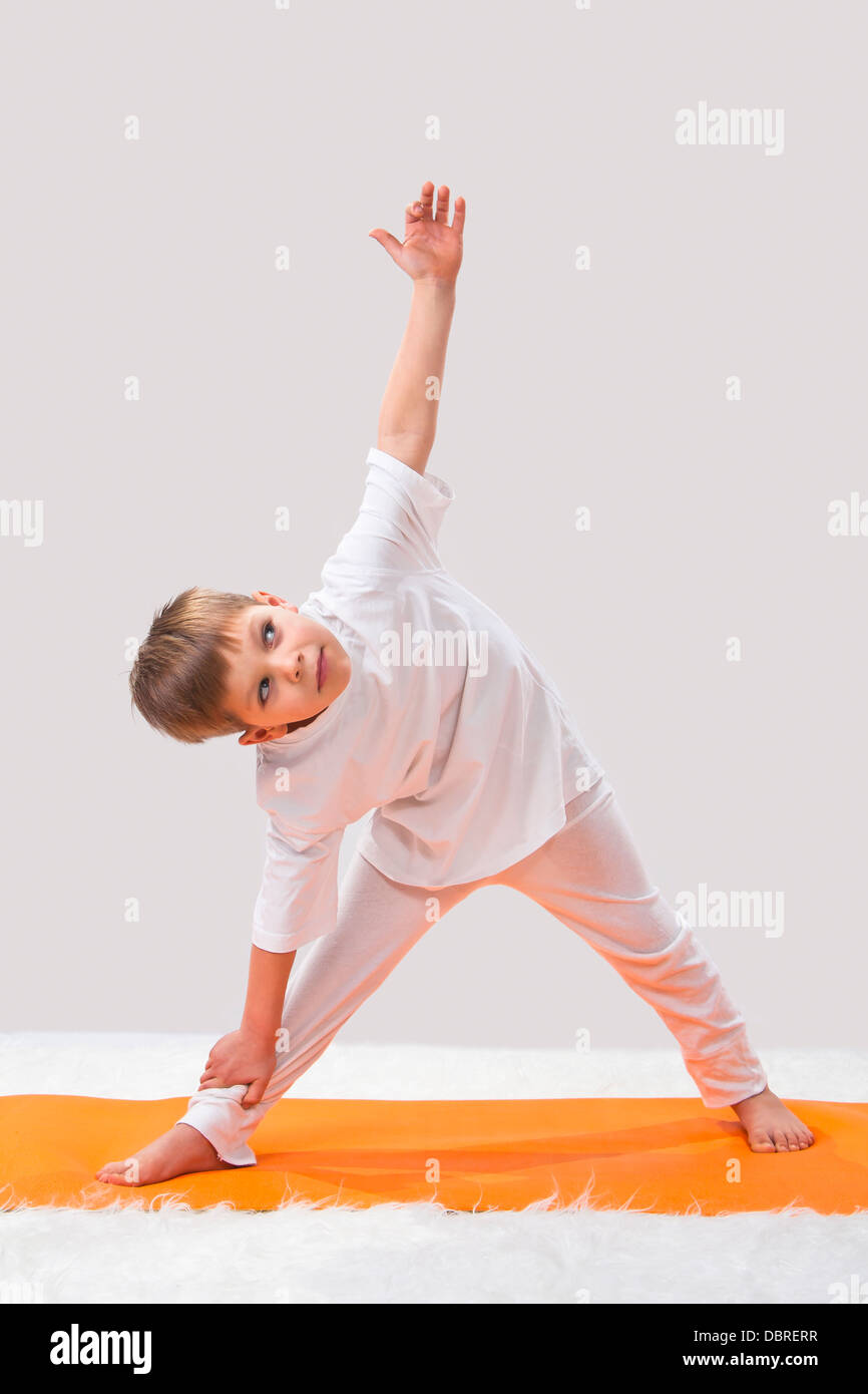 Children's yoga. The little boy does exercise Stock Photo - Alamy