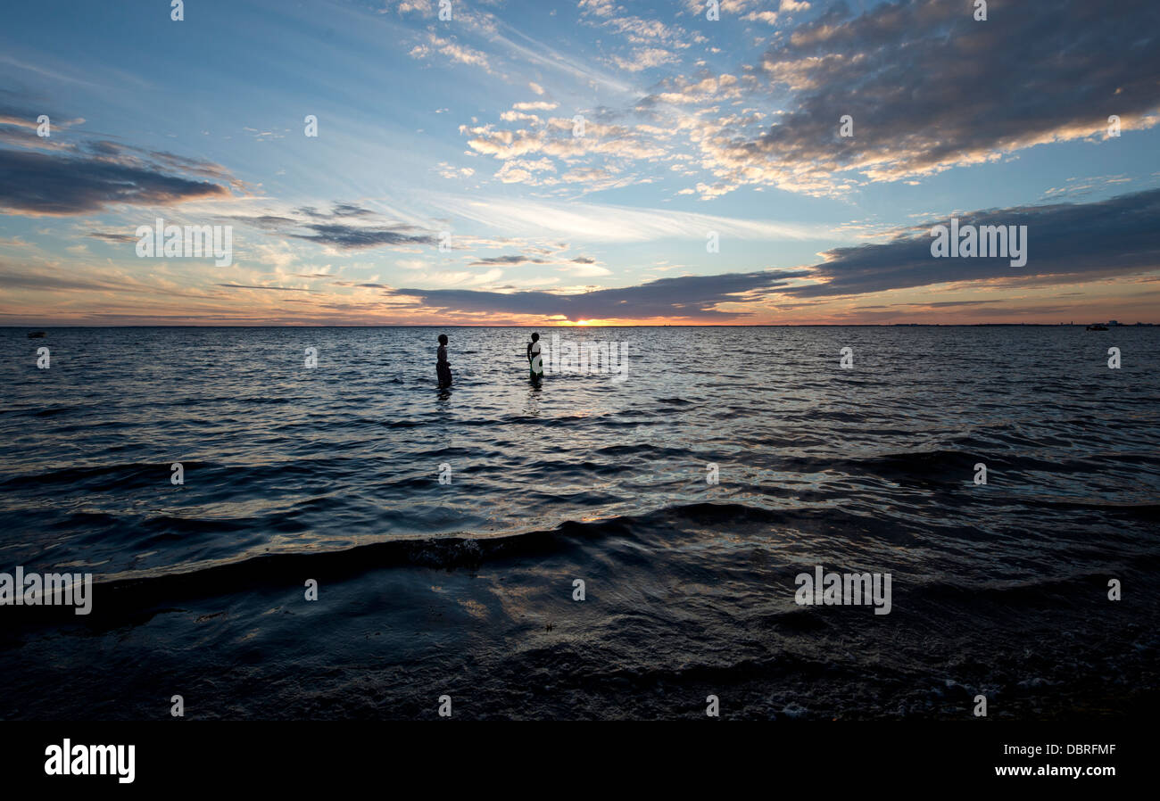Two young boys going for a night swim in the ocean Stock Photo - Alamy