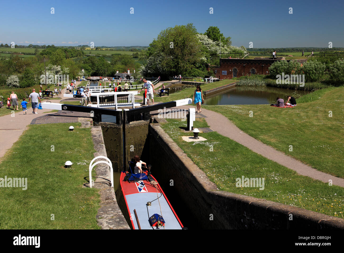 A narrowboat ascending Foxton Locks, on the Grand Union Canal, with the ...