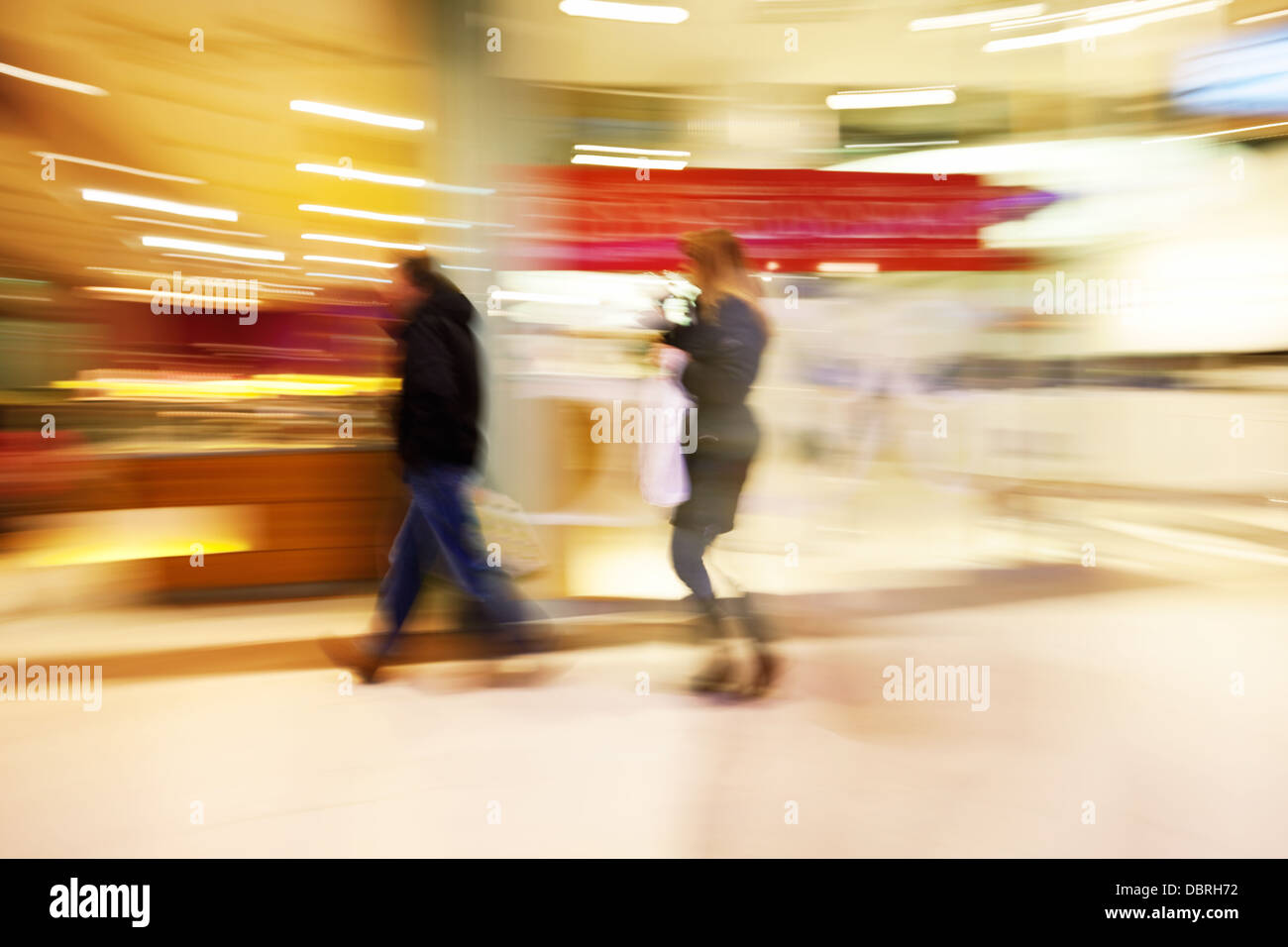 A shopper walking against shop window Stock Photo - Alamy