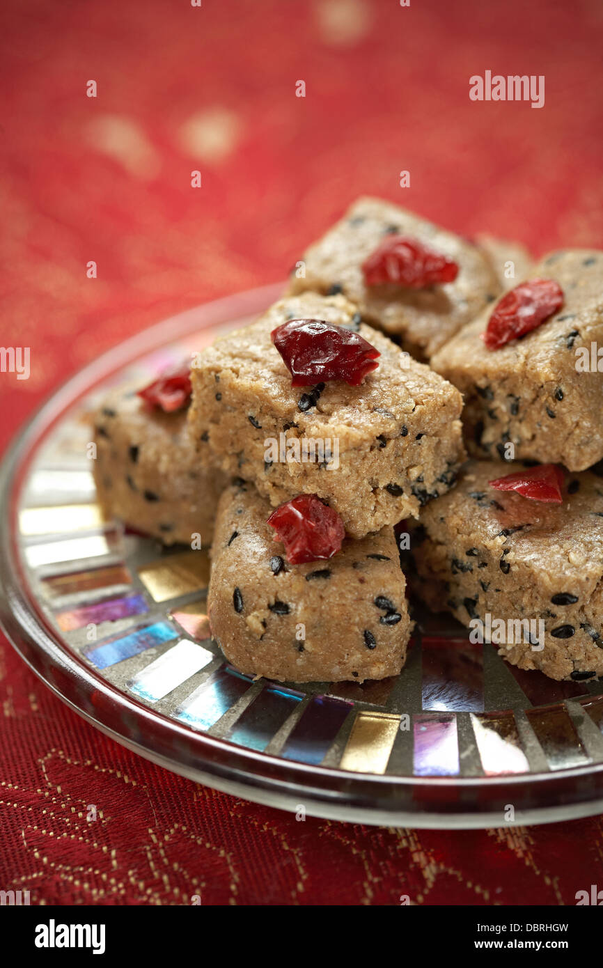 Halva Cubes on a pretty glass tray and rich red table cloth Stock Photo ...