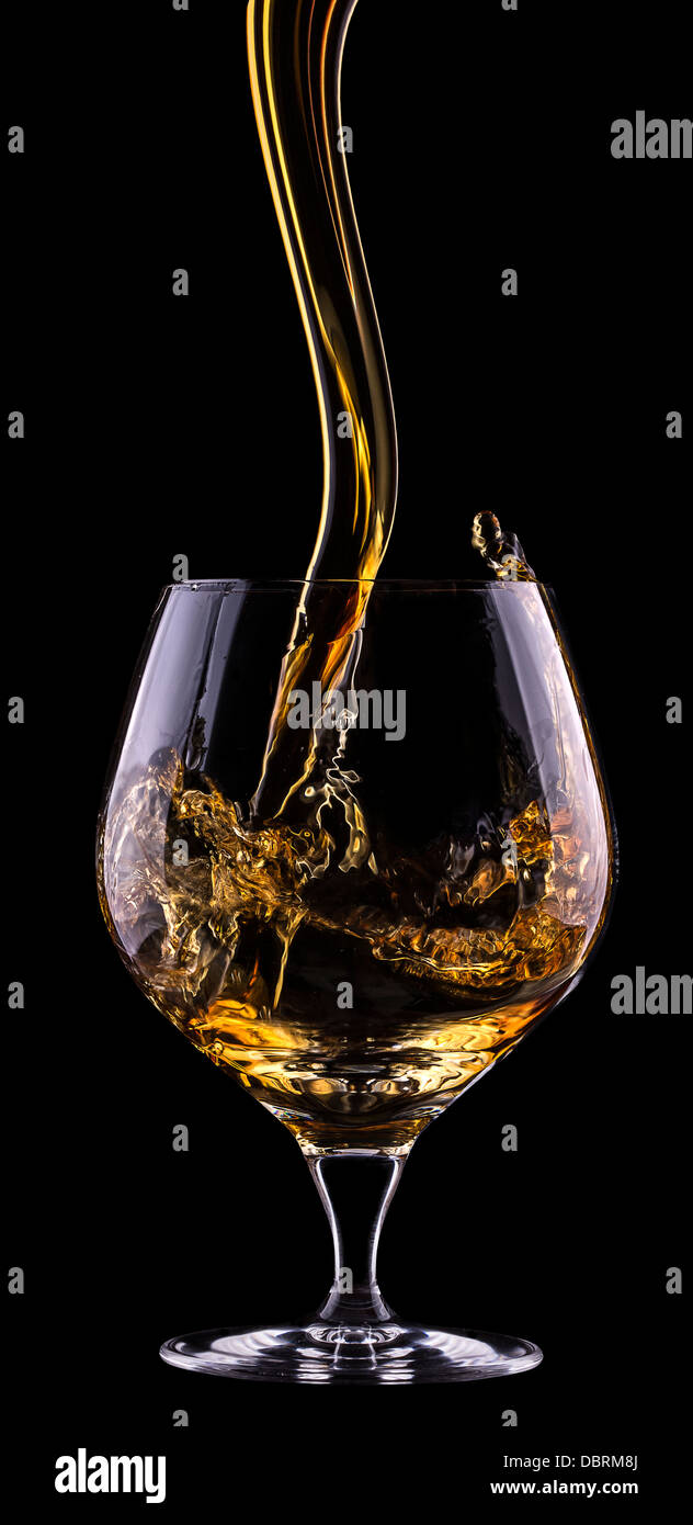 Cognac or brandy on a black background Stock Photo - Alamy