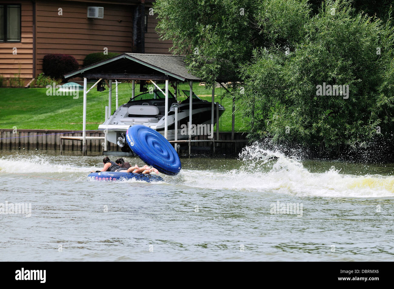 Teenagers tubbing on a river Stock Photo - Alamy