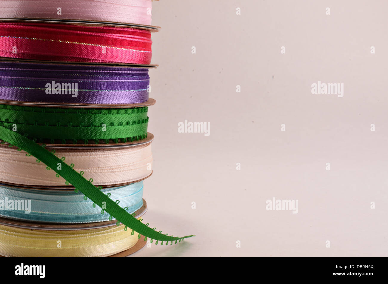 A stack of spools of ribbon on a white background Stock Photo - Alamy