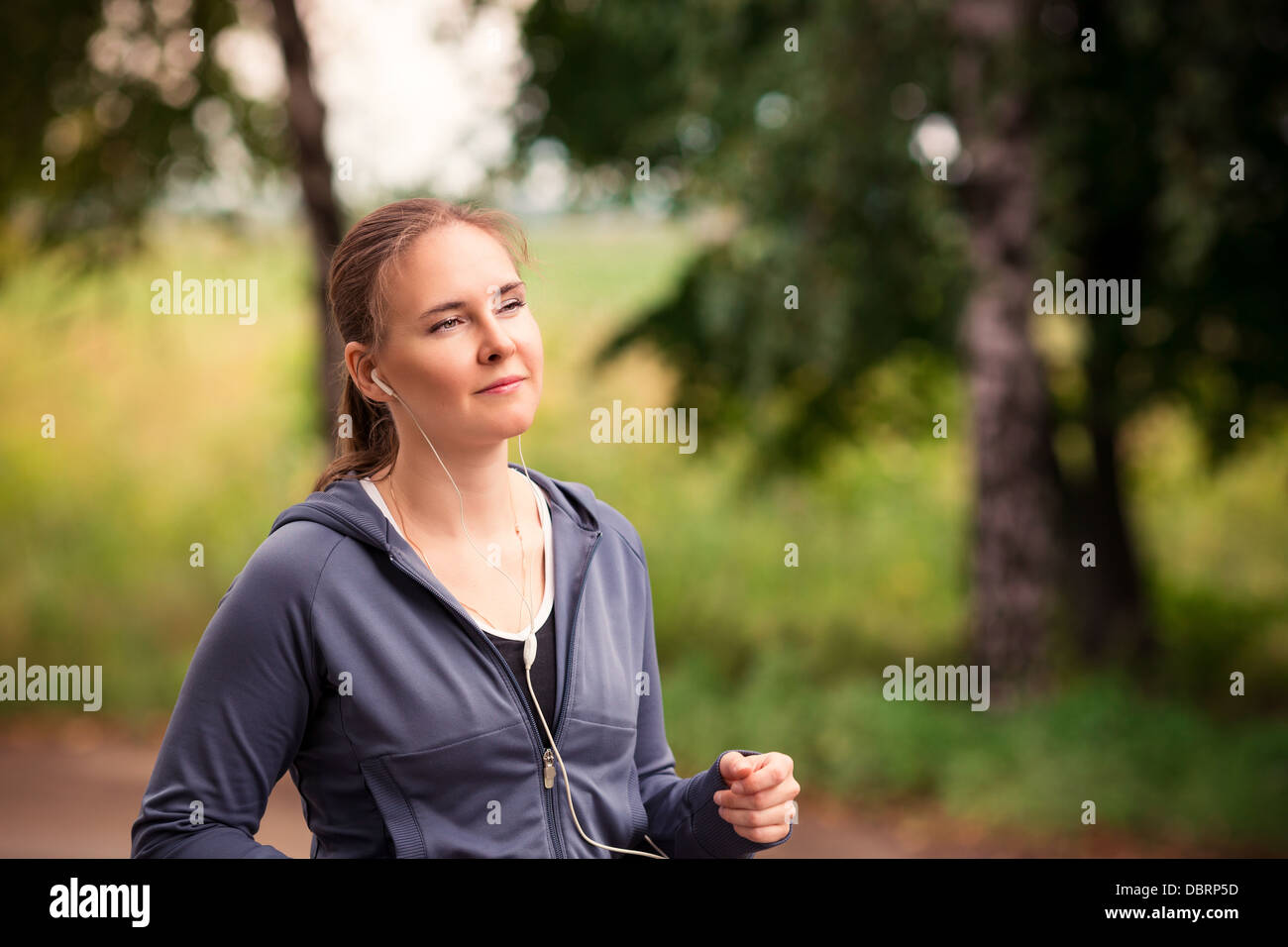 Beautiful fit runner woman jogging in nature outdoor Stock Photo - Alamy