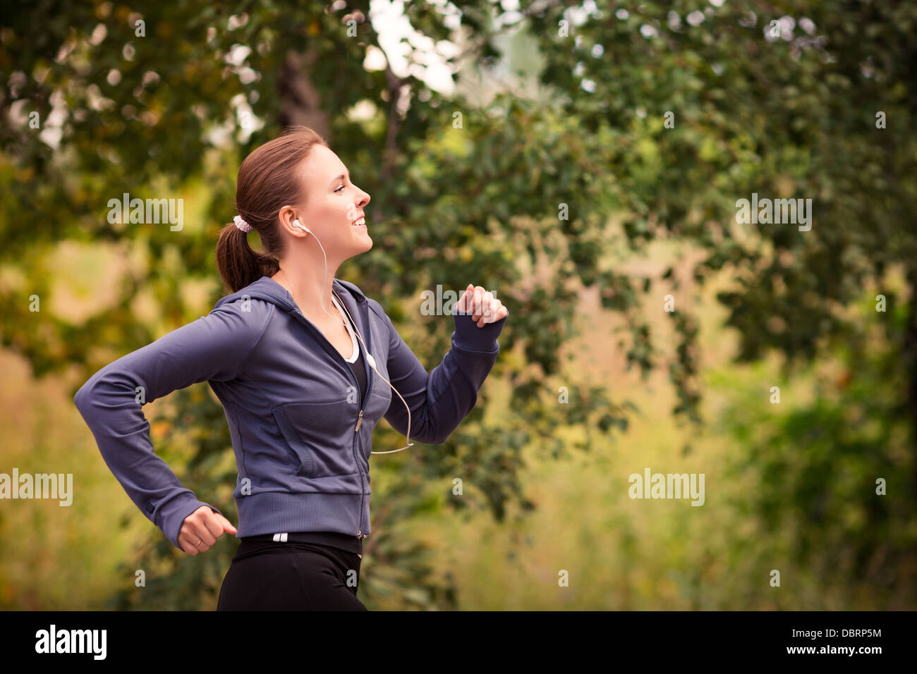 Beautiful fit runner woman jogging in nature outdoor Stock Photo - Alamy