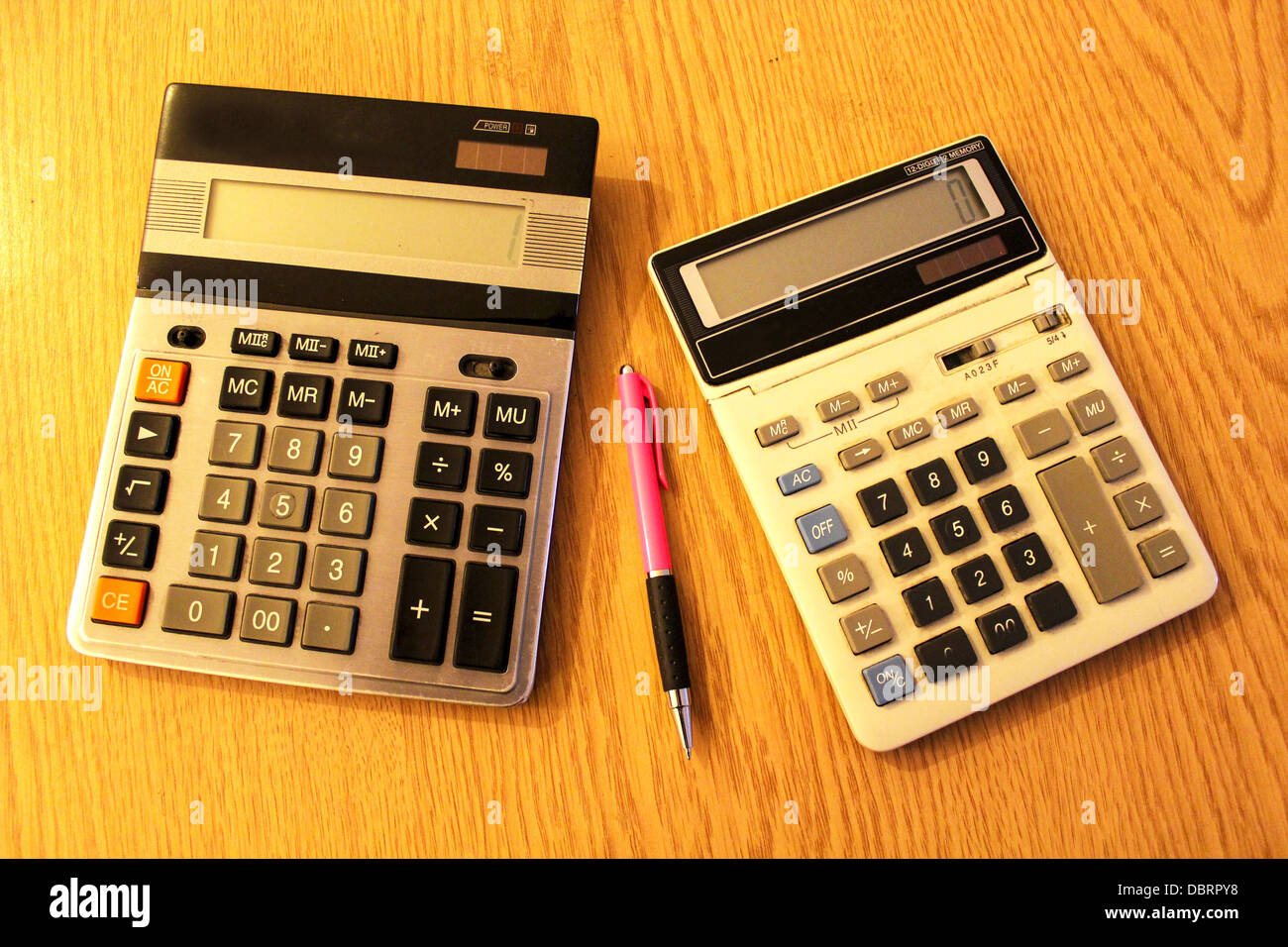 The image of pair of calculators on a table and the pen Stock Photo - Alamy